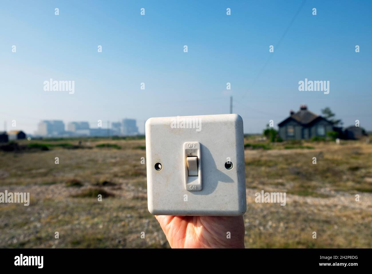 Hand holding discarded plastic flat plate light switch and the ...