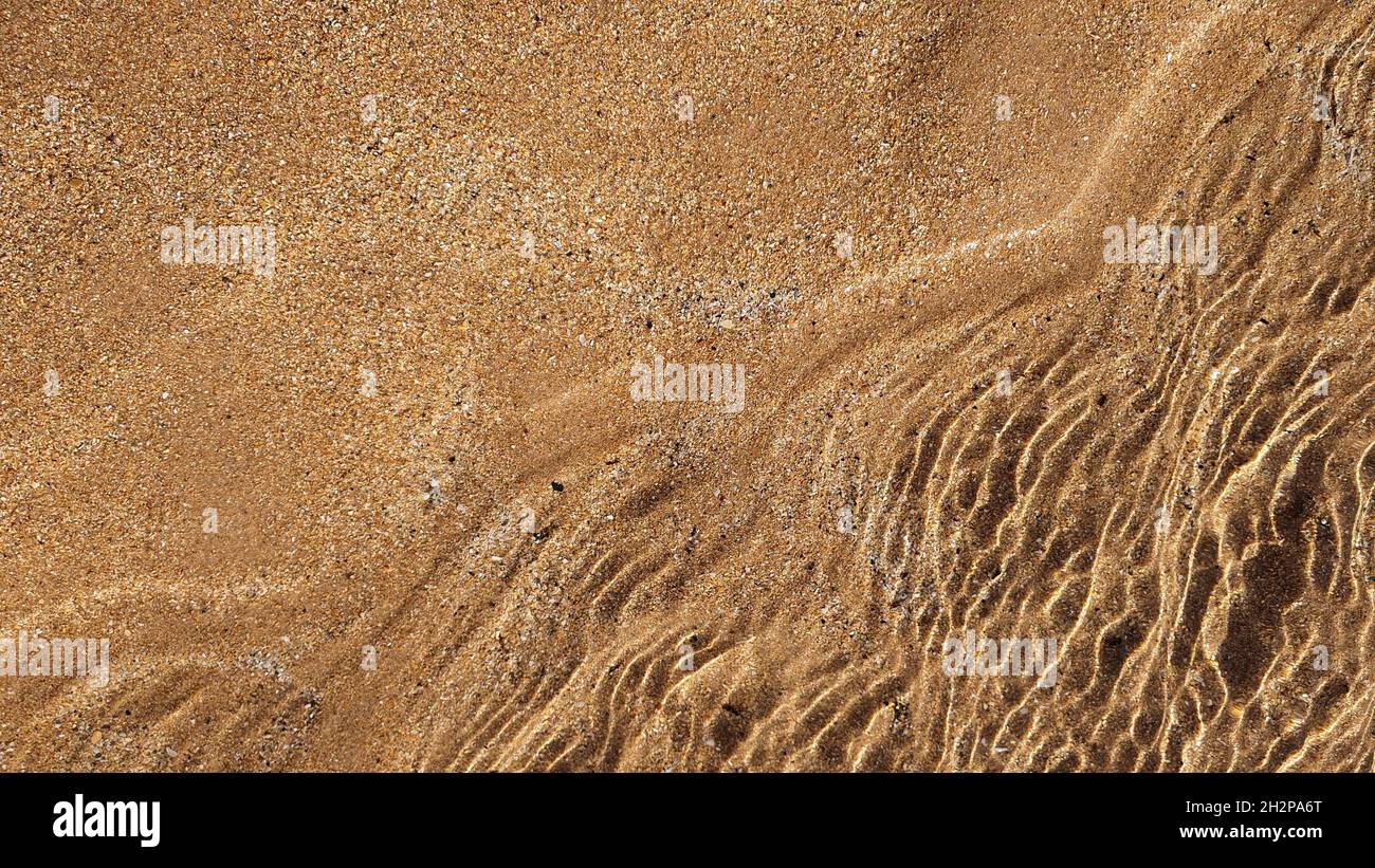 Pattern and textures in sand Stock Photo - Alamy