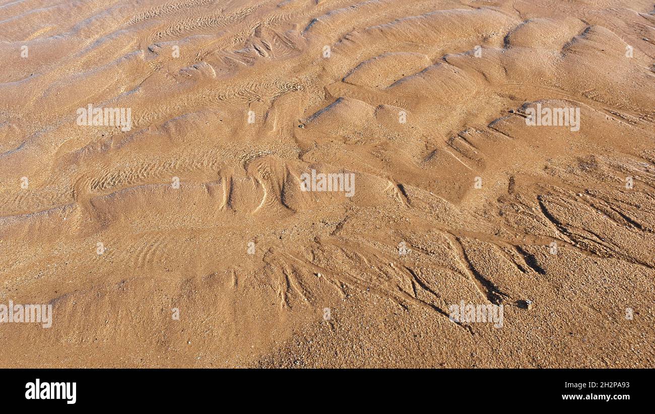 Pattern and textures in sand Stock Photo - Alamy