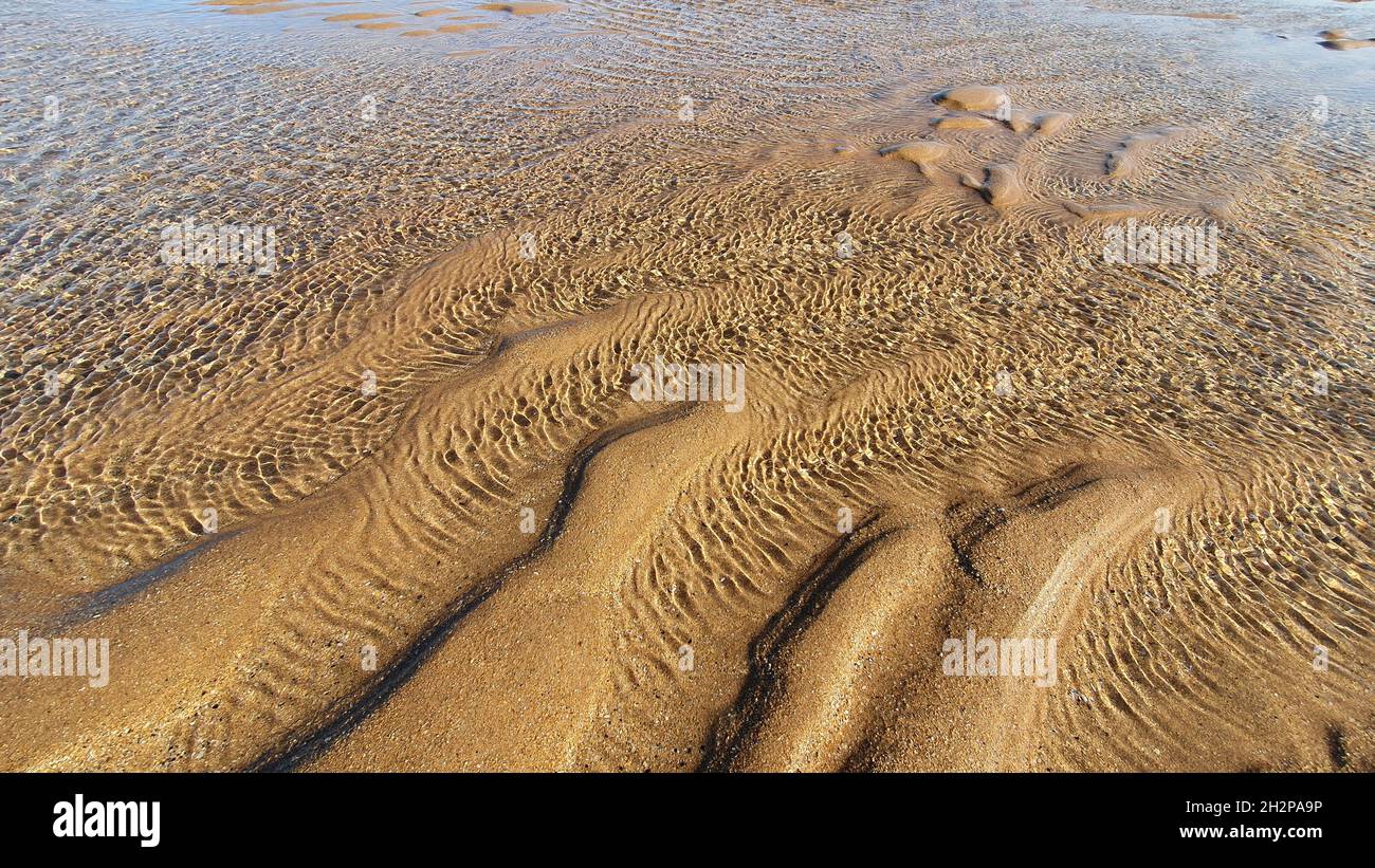 Pattern and textures in sand Stock Photo - Alamy