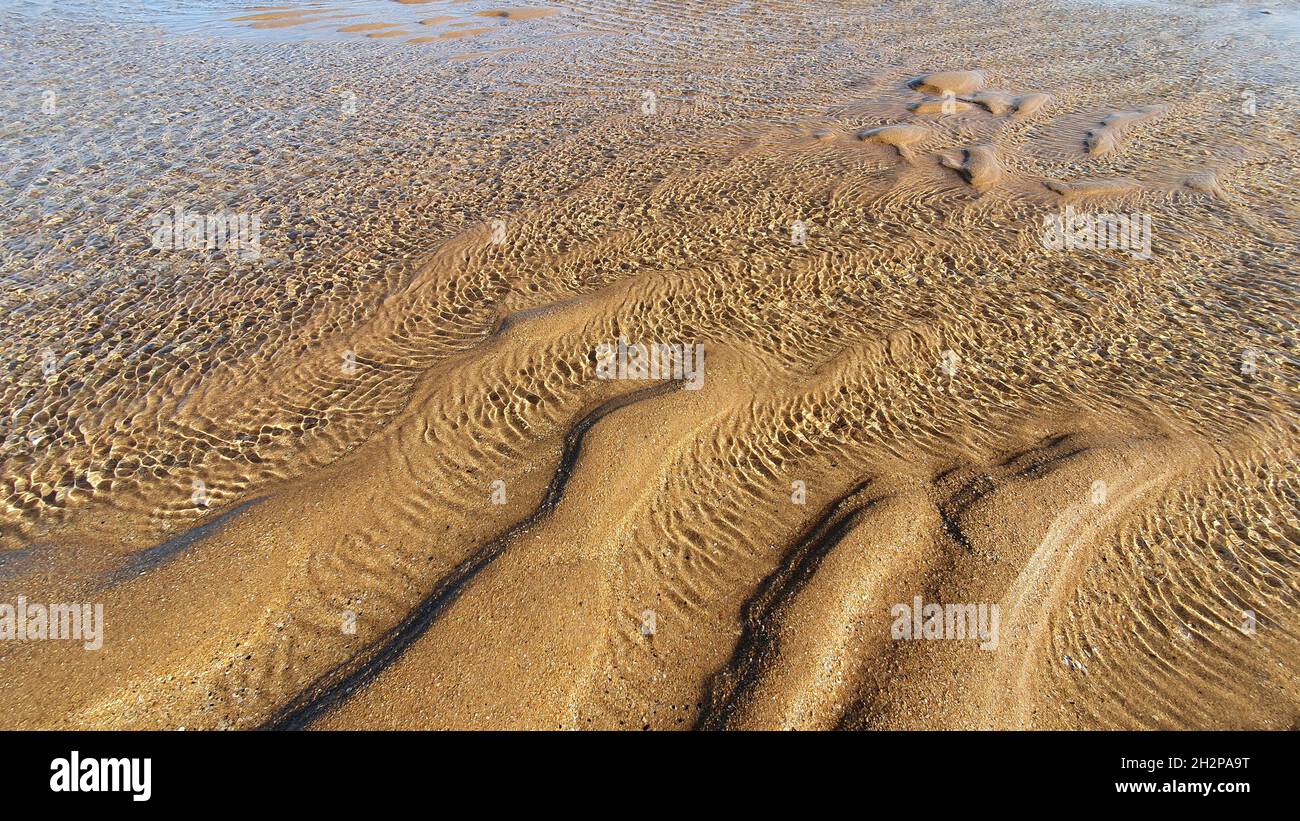 Pattern and textures in sand Stock Photo - Alamy
