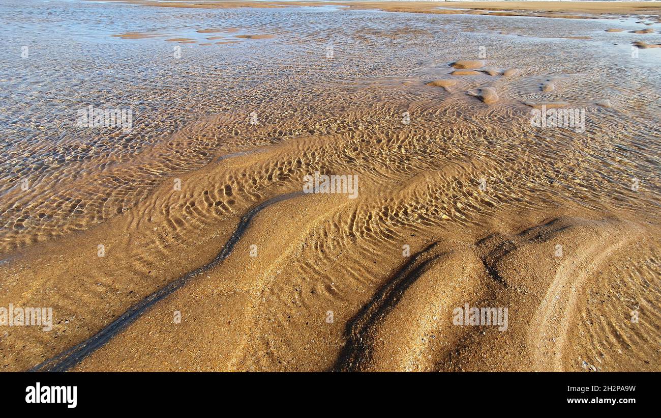 Pattern and textures in sand Stock Photo - Alamy