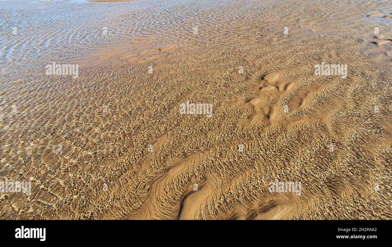 Pattern and textures in sand Stock Photo - Alamy