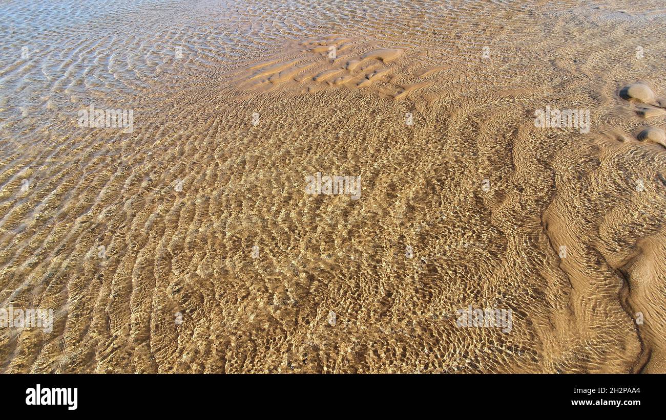 Pattern and textures in sand Stock Photo - Alamy