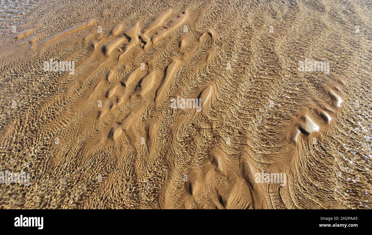 Pattern and textures in sand Stock Photo - Alamy