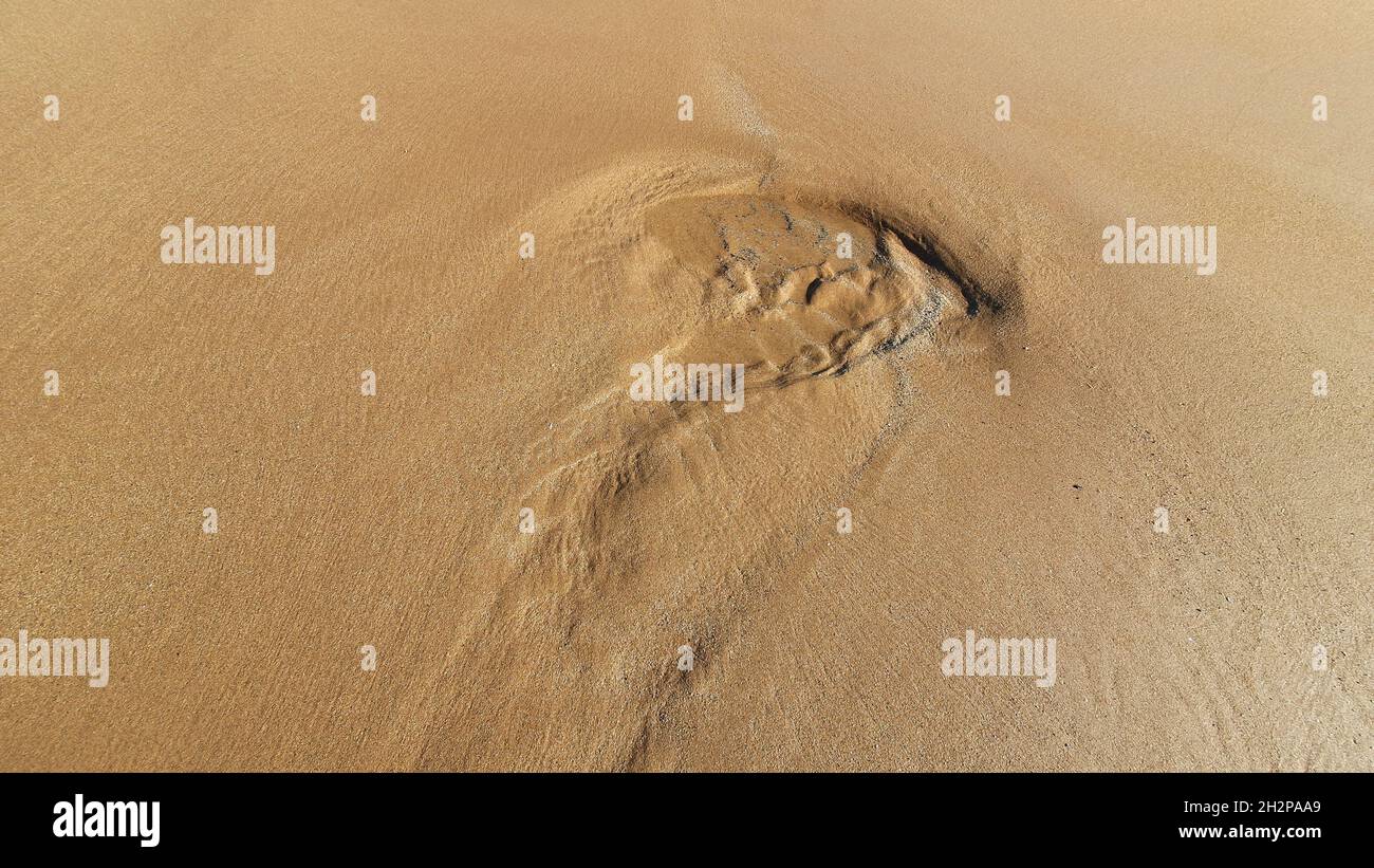 Pattern and textures in sand Stock Photo - Alamy