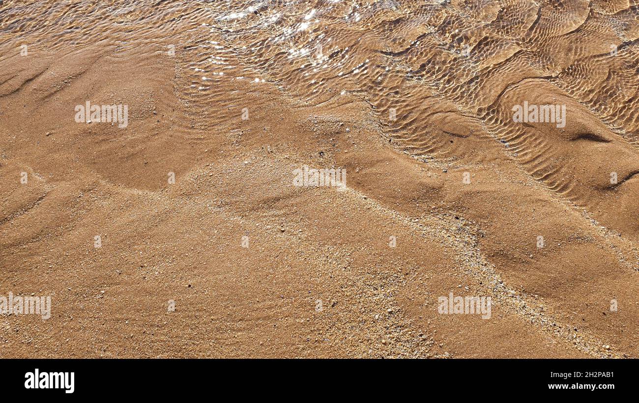 Pattern and textures in sand Stock Photo - Alamy