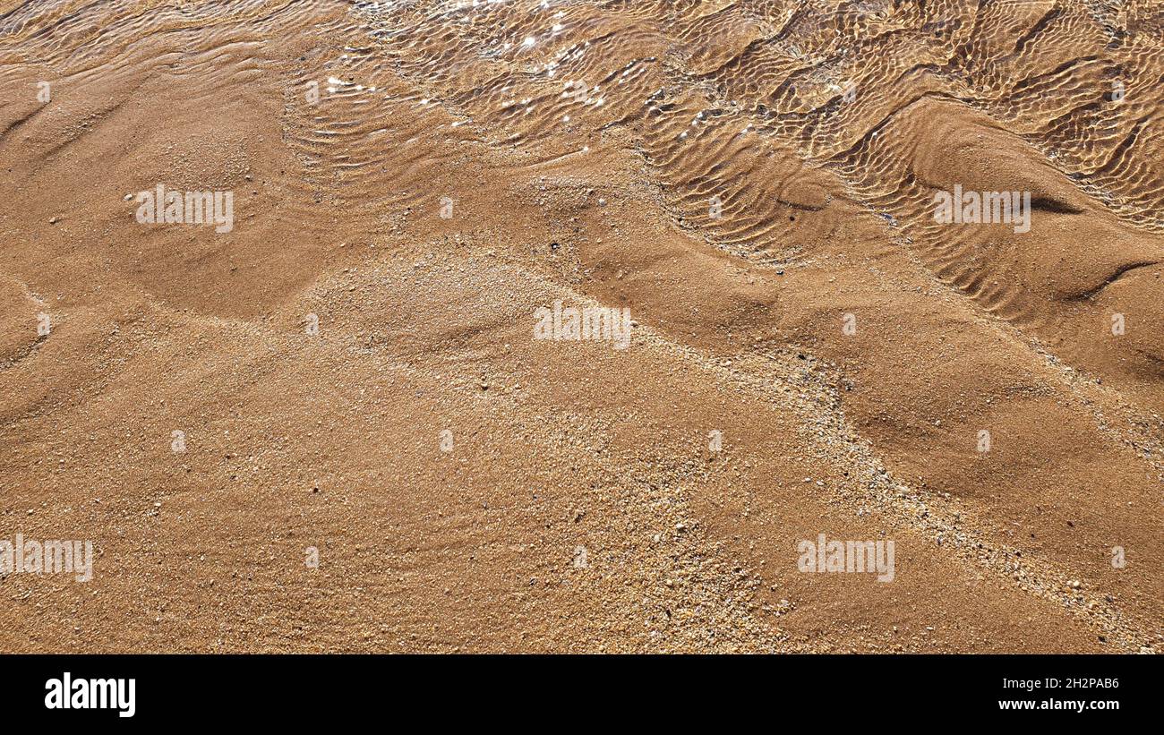 Pattern and textures in sand Stock Photo - Alamy