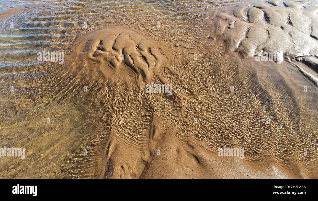 Pattern and textures in sand Stock Photo - Alamy