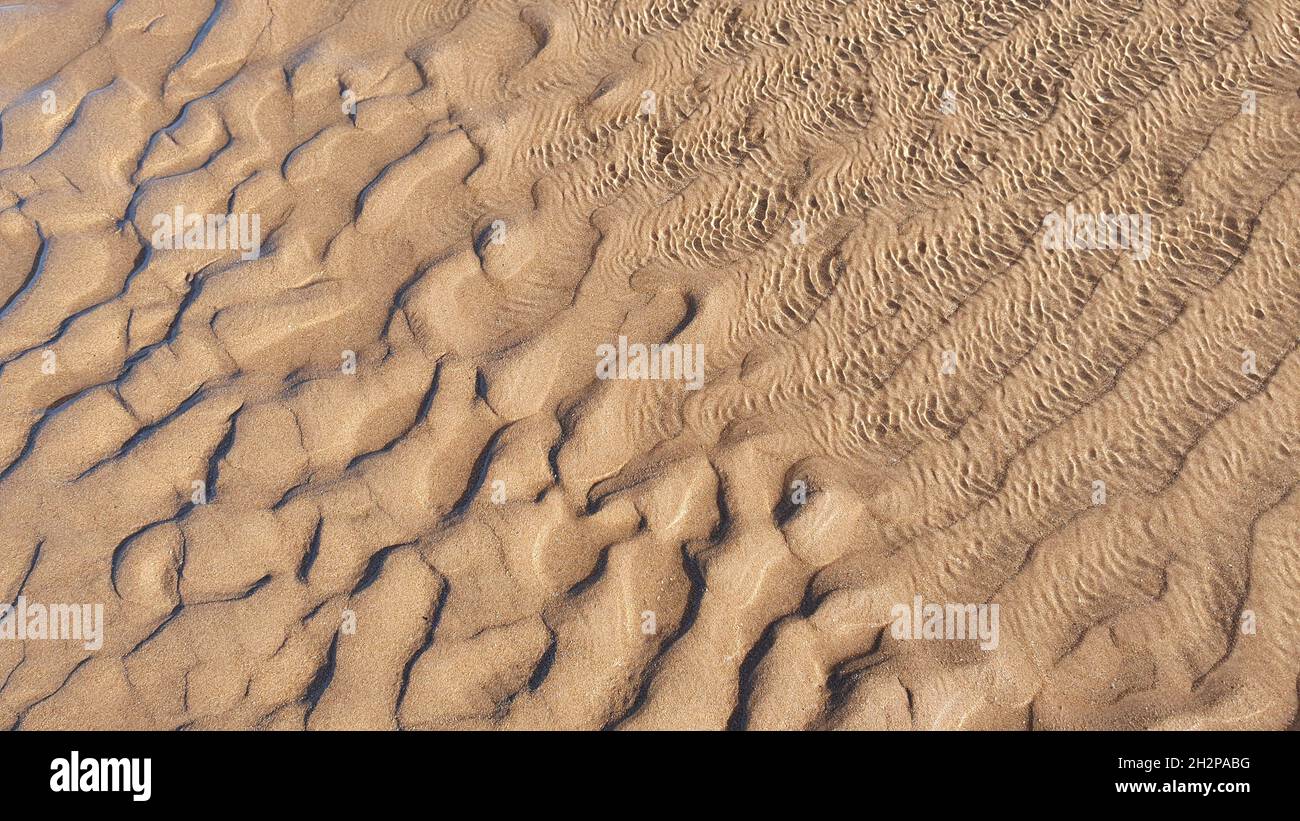 Pattern and textures in sand Stock Photo - Alamy