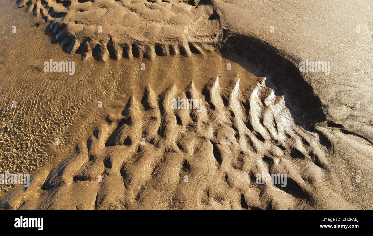 Pattern and textures in sand Stock Photo - Alamy