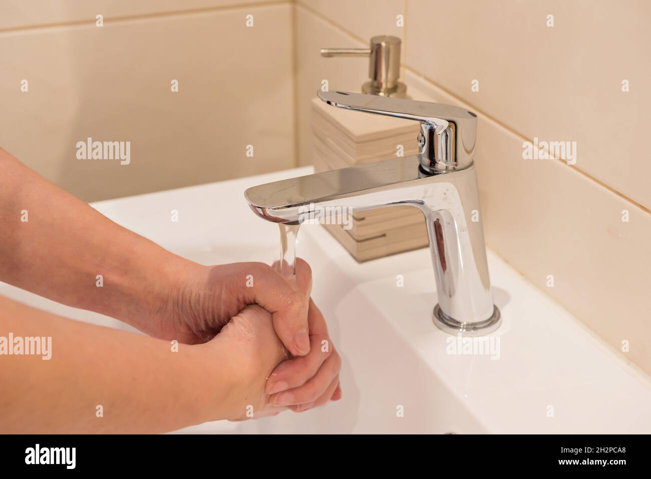 Washing of hands with soap under running water Stock Photo - Alamy
