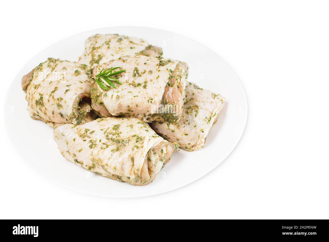 Raw marinated chicken thighs in sauce on a white isolated background ...