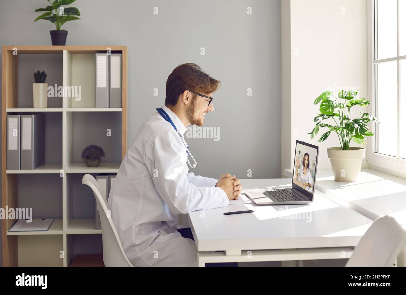 Doctor having online consultation with patient via video call on laptop ...