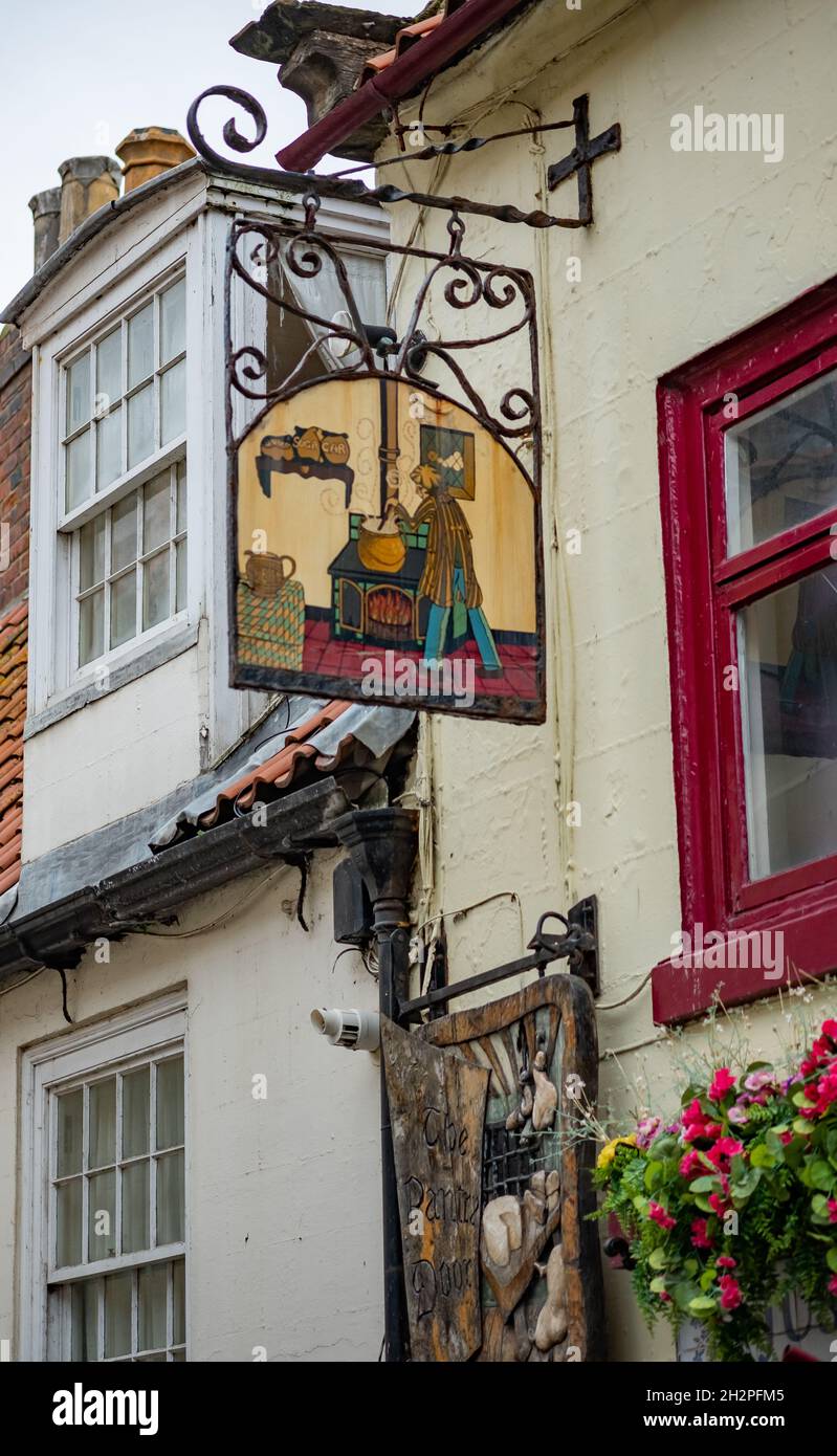 Whitby, Yorkshire, UK – October 20 2021. Decorative metal sign hanging ...