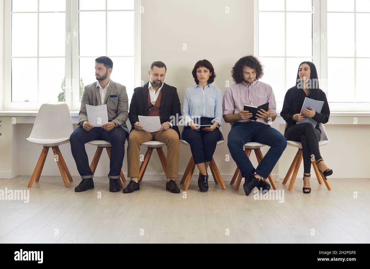 Group of people sitting in office waiting for job interview or business ...