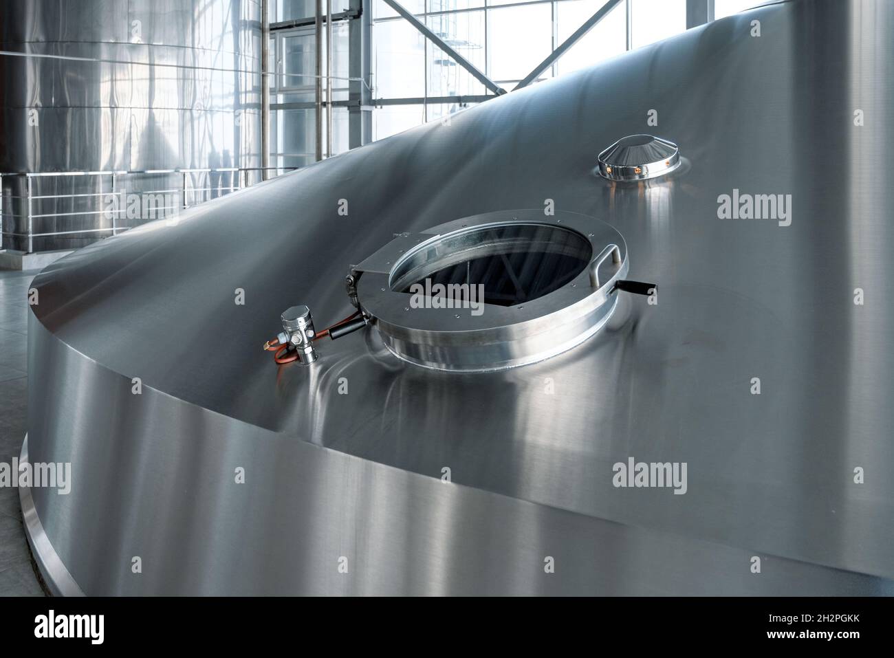 Large steel tanks for yeast fermentation. Industrial production of beer ...