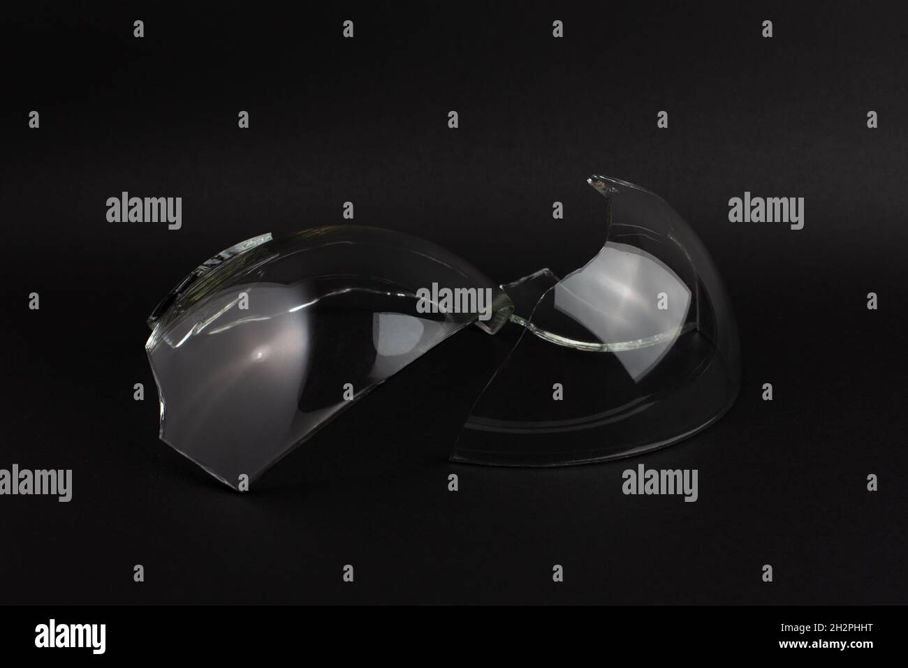 Broken glass pieces on black background Stock Photo - Alamy