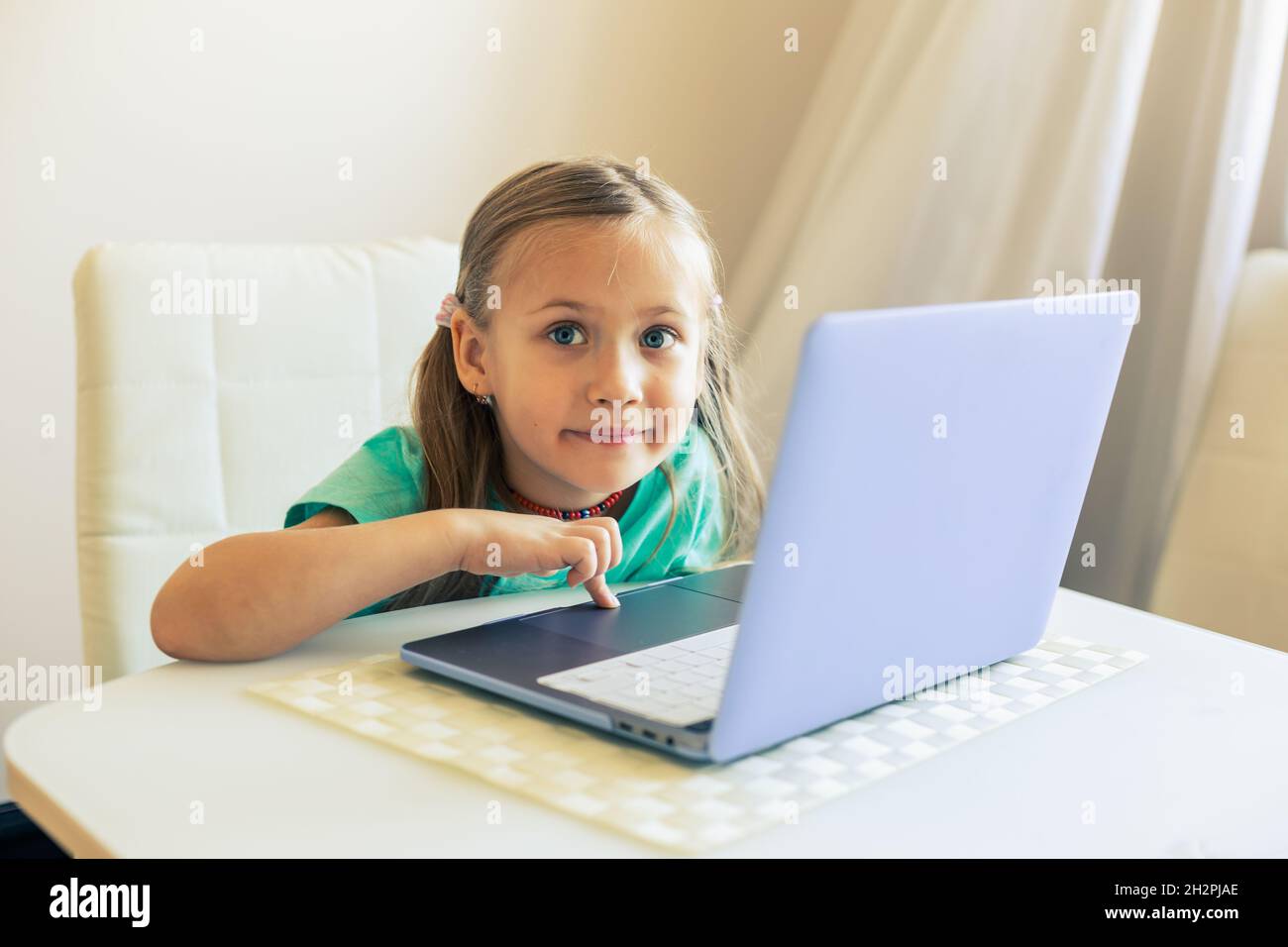 Little cute girl uses laptop to have video call Stock Photo - Alamy