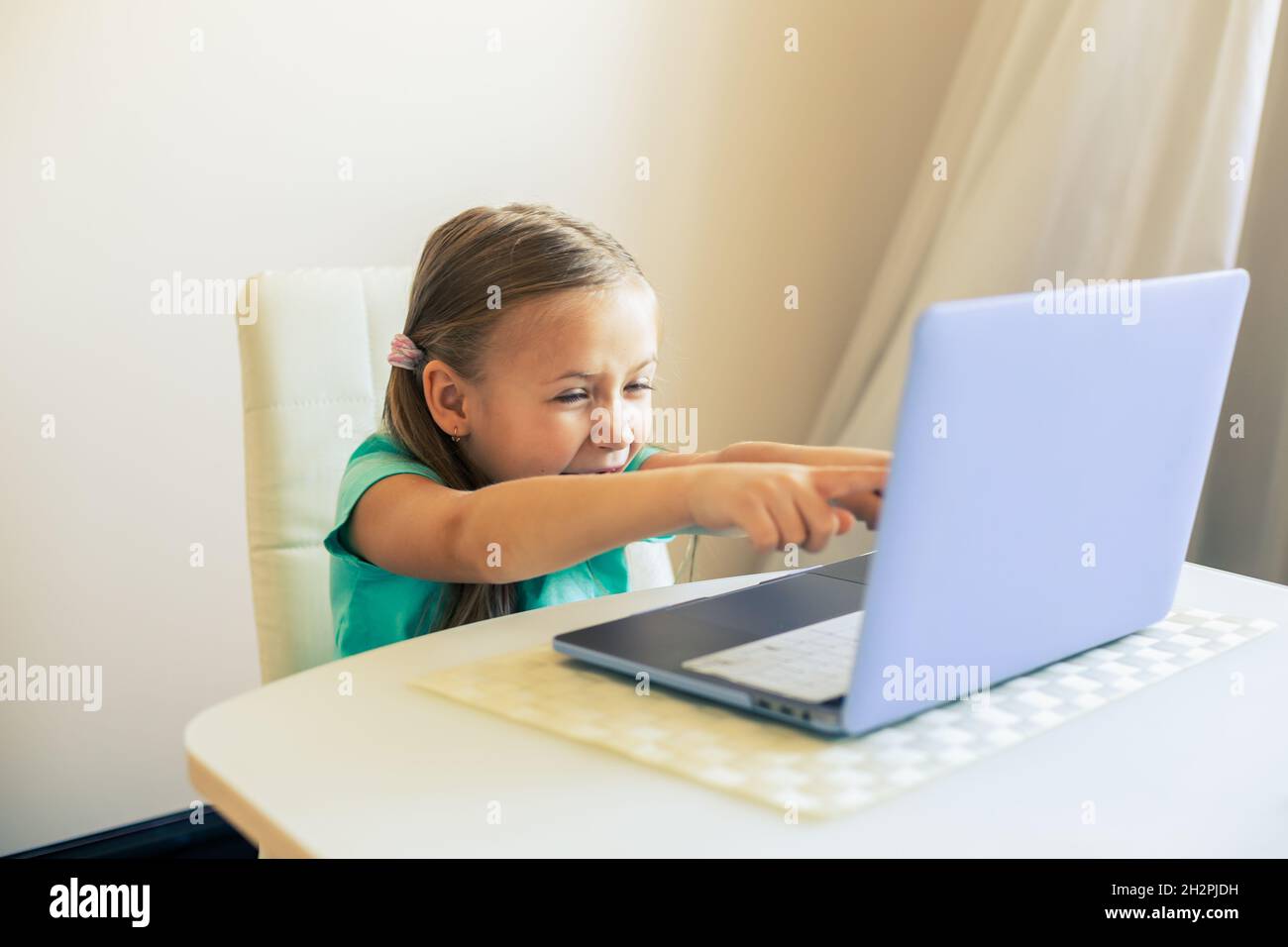 Little cute girl uses laptop to have video call Stock Photo - Alamy