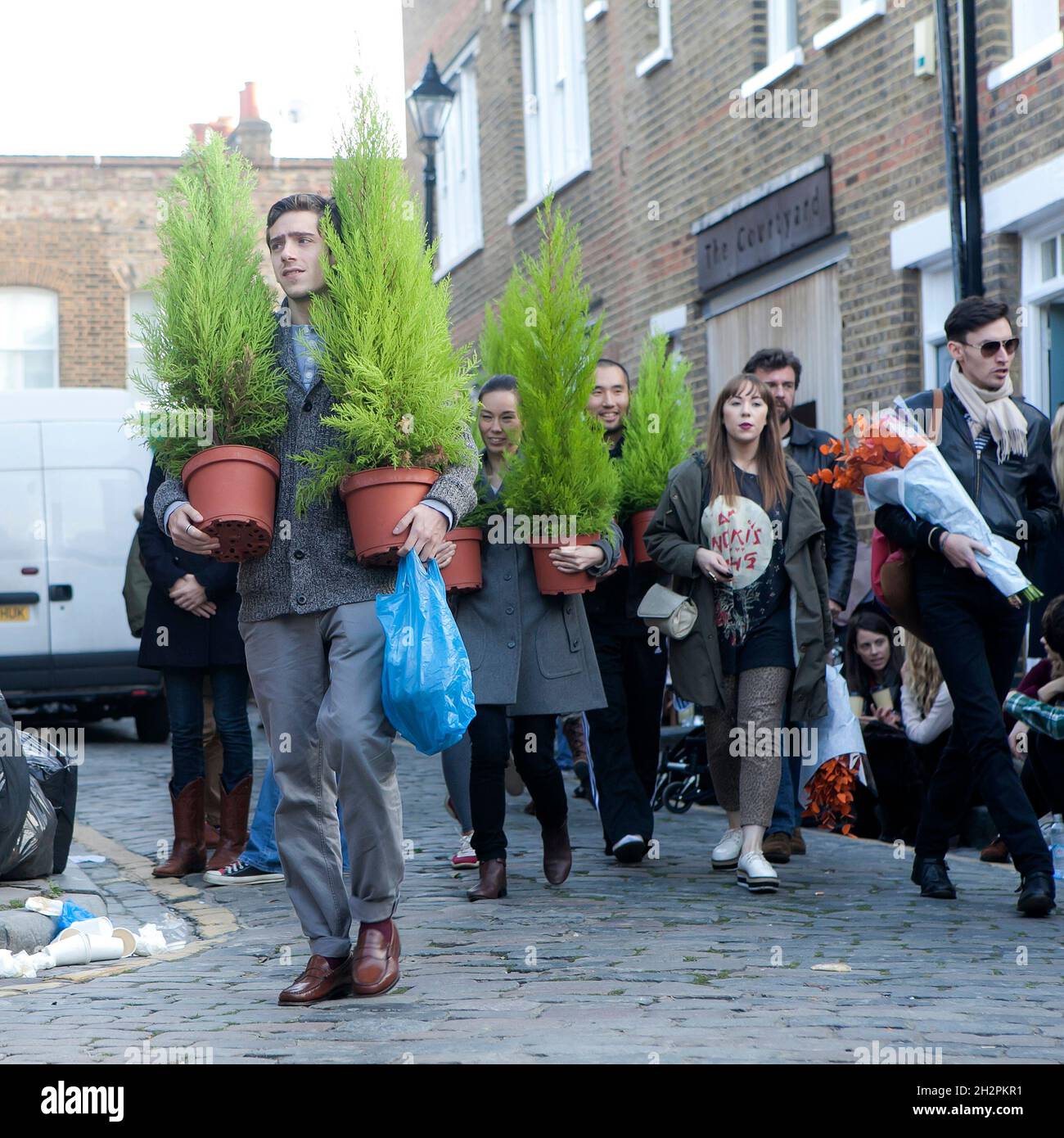 London, UK - 20 November 2019, A group of friends bought potted thuja ...