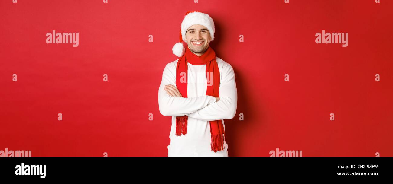 Handsome caucasian guy with bristle, wearing santa hat, scarf and white ...
