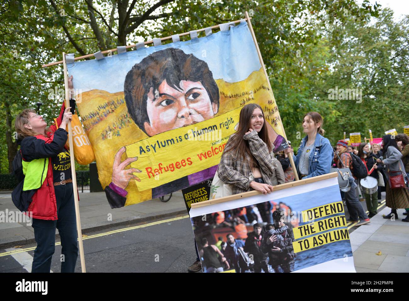 Protesters hold a banner during a rally opposite the Embassy of Italy ...