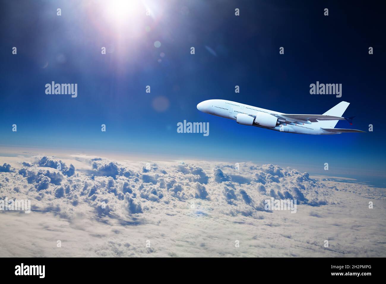 Big jet plane fly above clouds at high altitude Stock Photo - Alamy