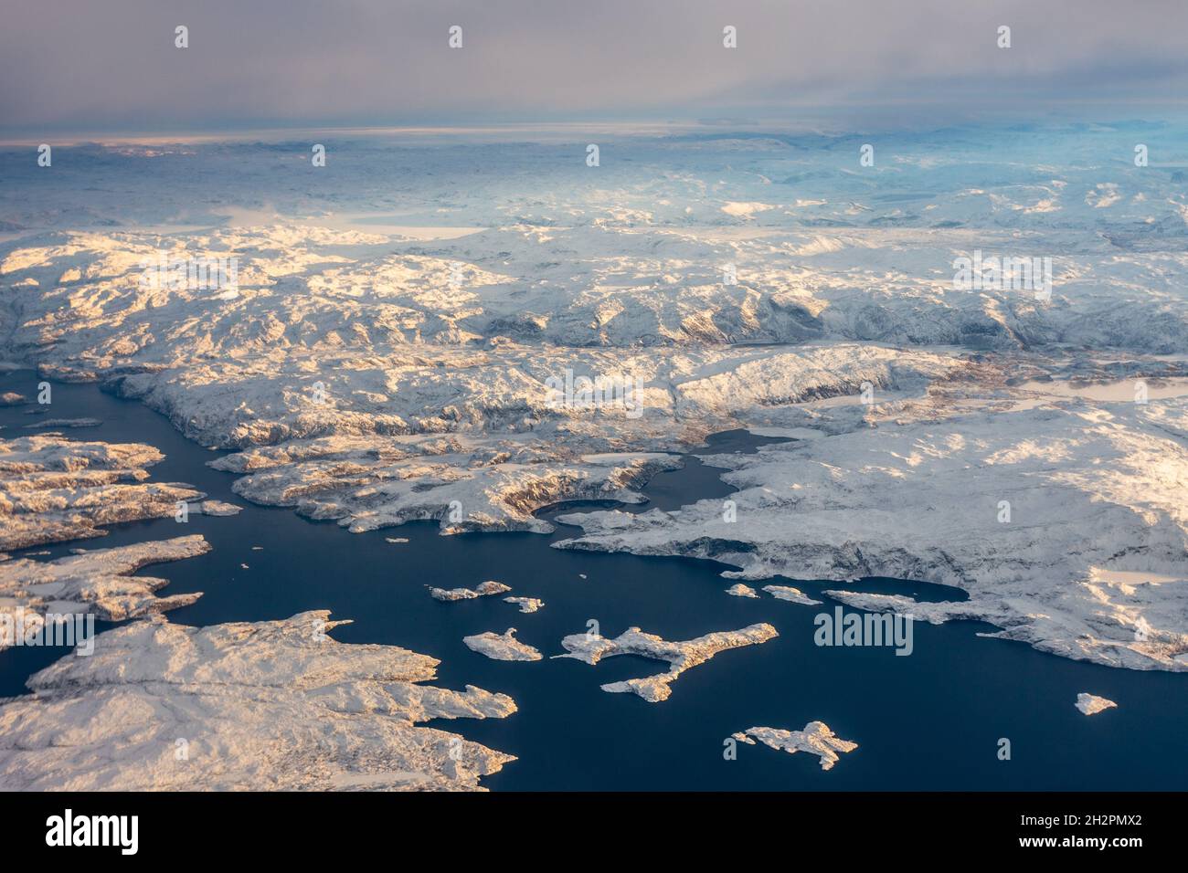 Greenlandic ice cap with frozen mountains and fjord aerial view, near ...