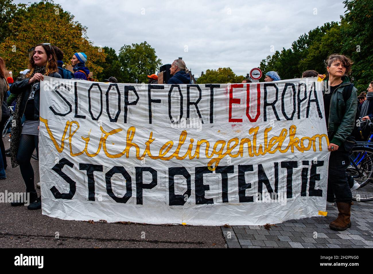 Protesters hold a banner during the demonstration.'We Are Here' is a ...