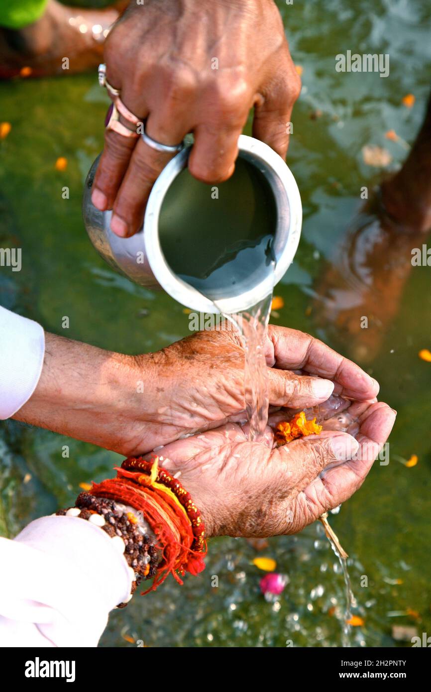 INDIA. DETAIL OF THE HANDS DURING THE PUJA ON THE BANKS OF THE GANGES ...