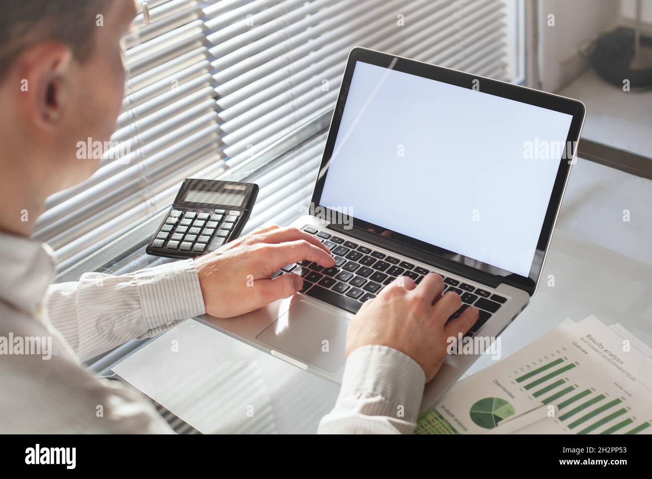 Business man working on computer laptop with empty blank screen in ...