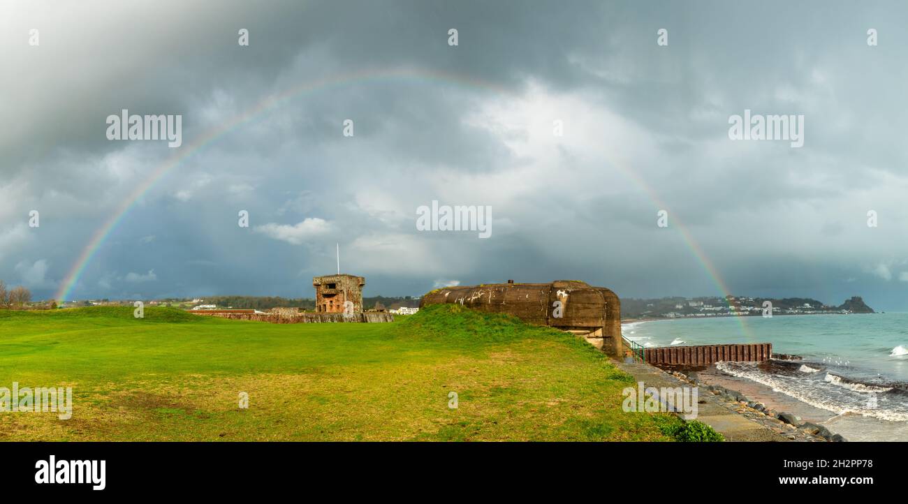 Rainbow over WWII concrete nazi bunker on the seashore with Fort Henry ...