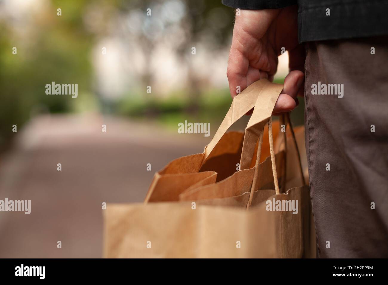 plastic free shopping concept, hand holding paper bags closeup Stock ...