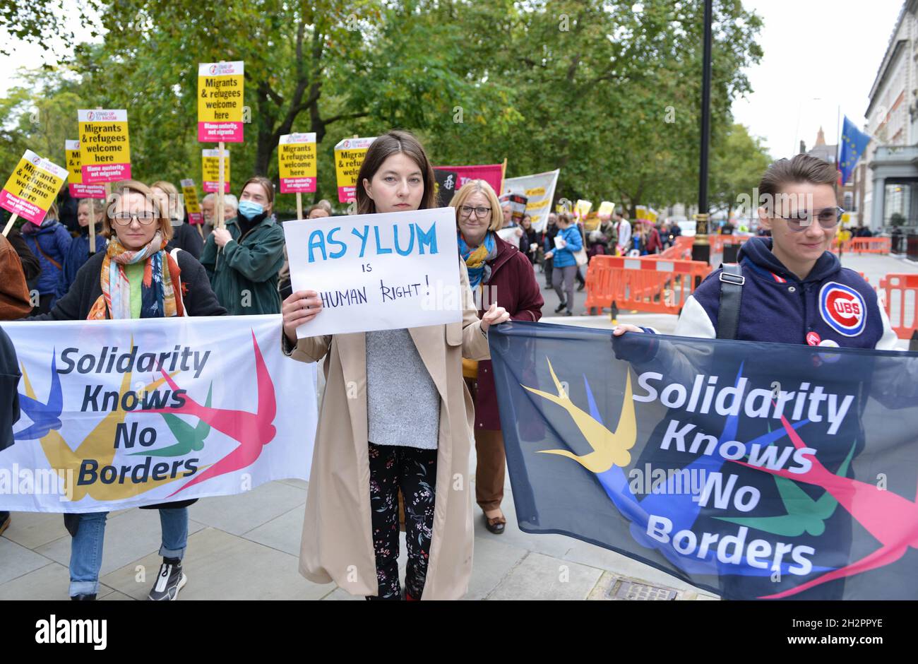 London, UK. 23rd Oct, 2021. Protesters hold placards and banners during ...
