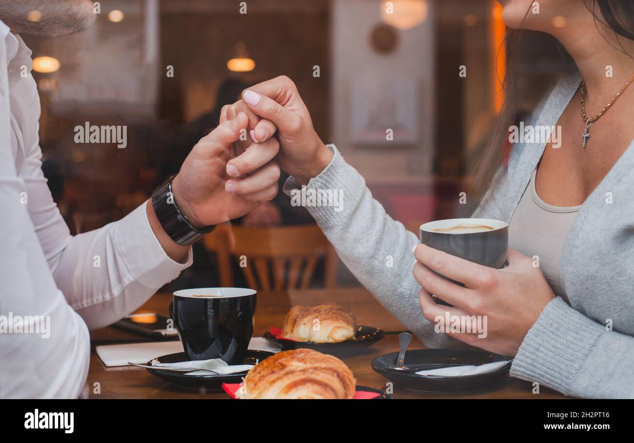 dating, romantic date in restaurant for couple, man and woman holding ...