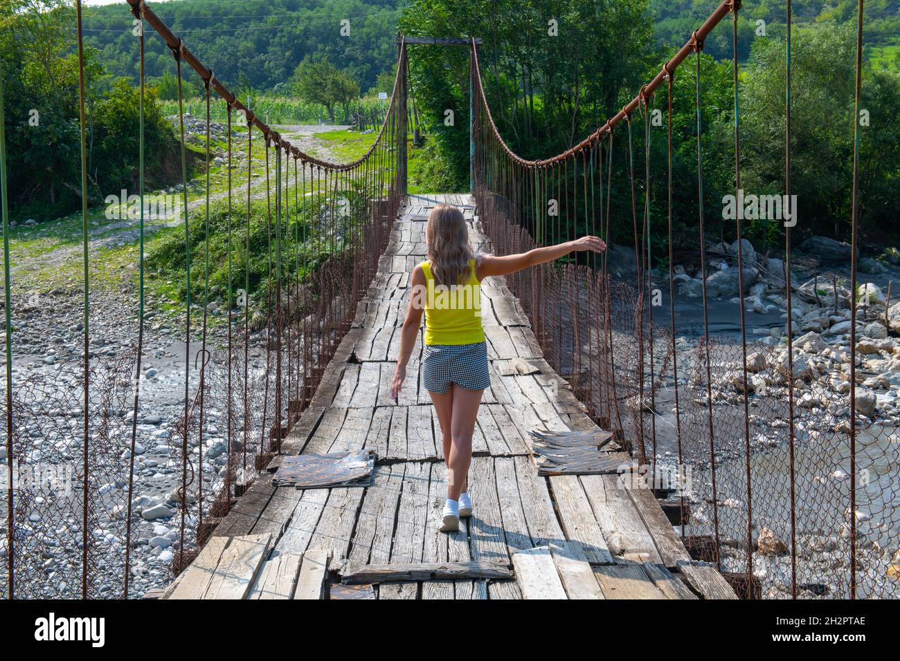a man walks on a suspension bridge in Georgia Stock Photo - Alamy