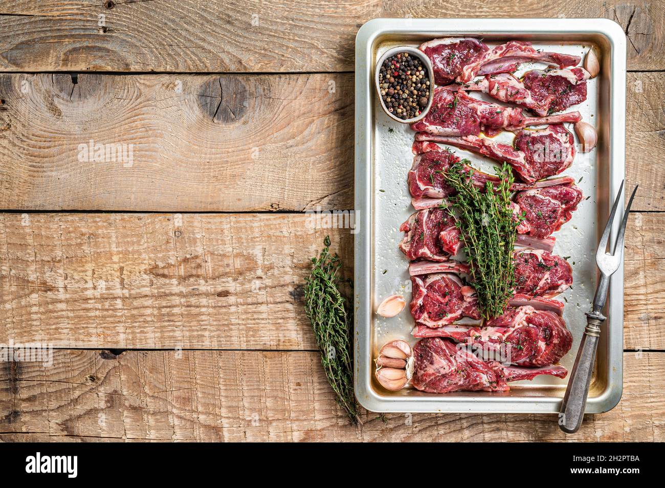 Raw uncooked lamb mutton meat chops steaks with thyme and garlic ...