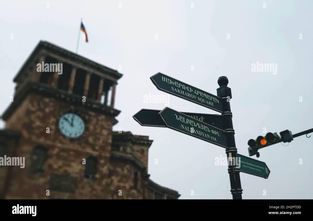 Low-angle shot of street signs and the clock tower in Republic Square ...