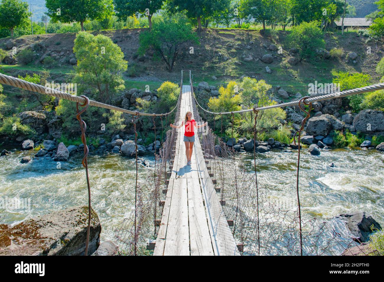 a girl stands in the middle of the underworld bridge in Georgia Stock ...