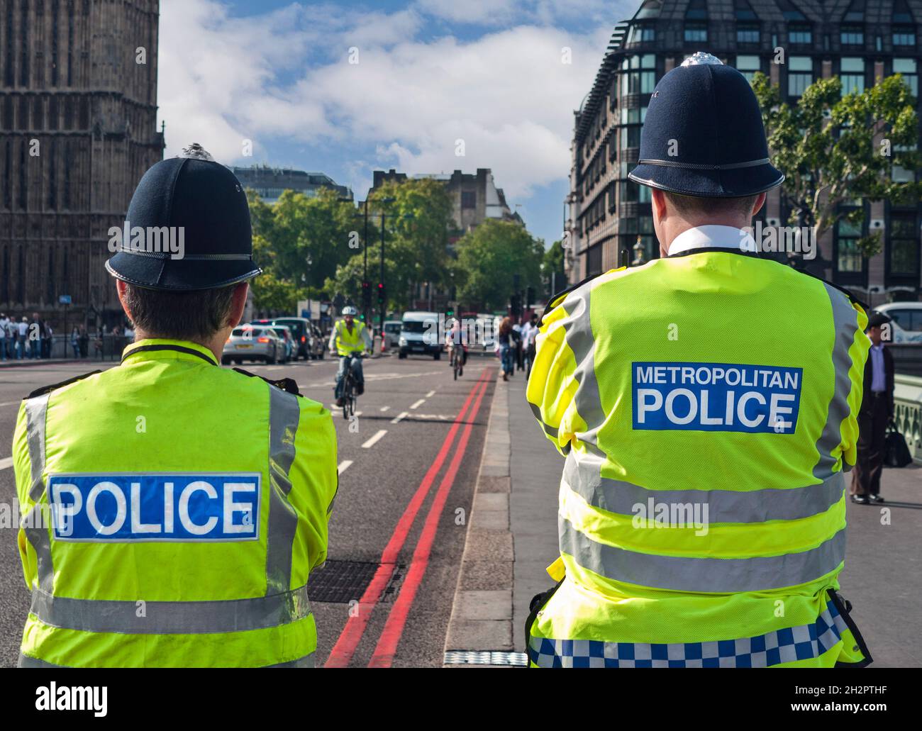 London Metropolitan Police officers from behind rear, wearing ...