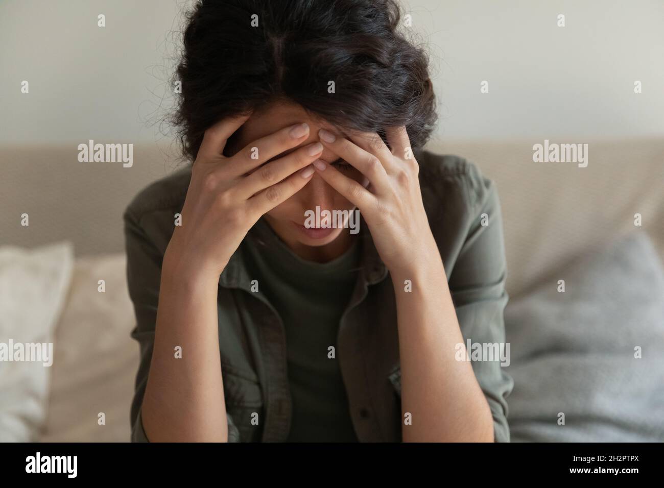 Concerned young woman thinking over personal problem, feeling depressed ...