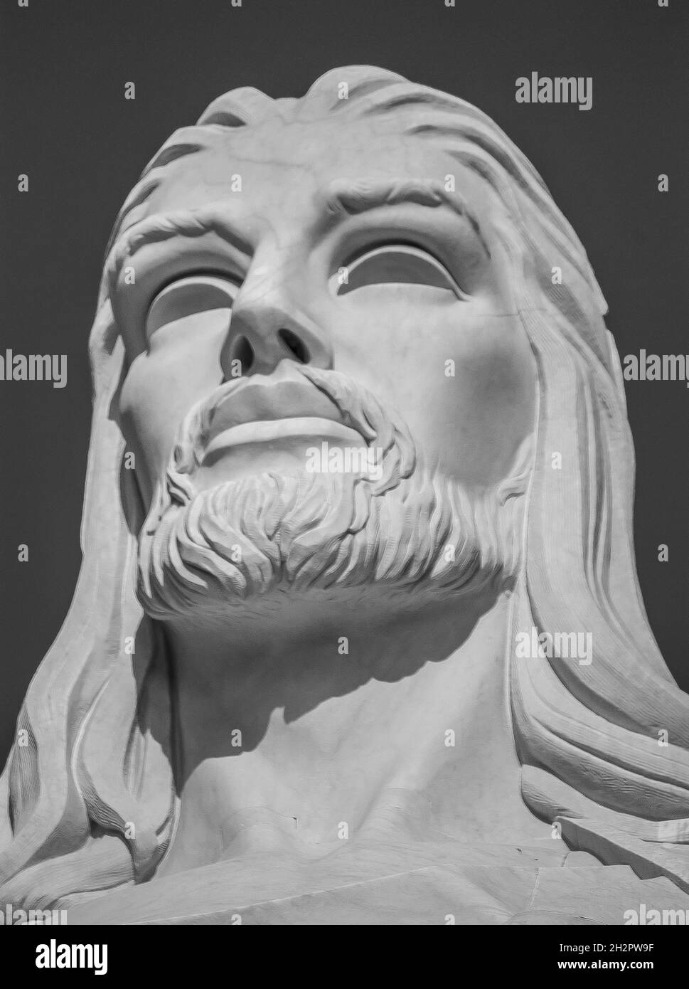 Head of Christ of Havana statue on a gray background, grayscale ...