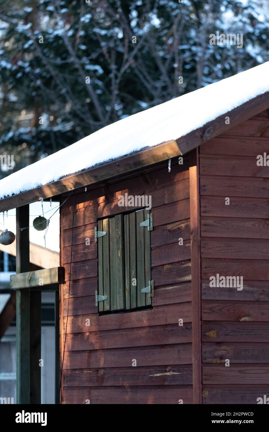 A small wooden children's house covered with snow. Picturesque winter ...