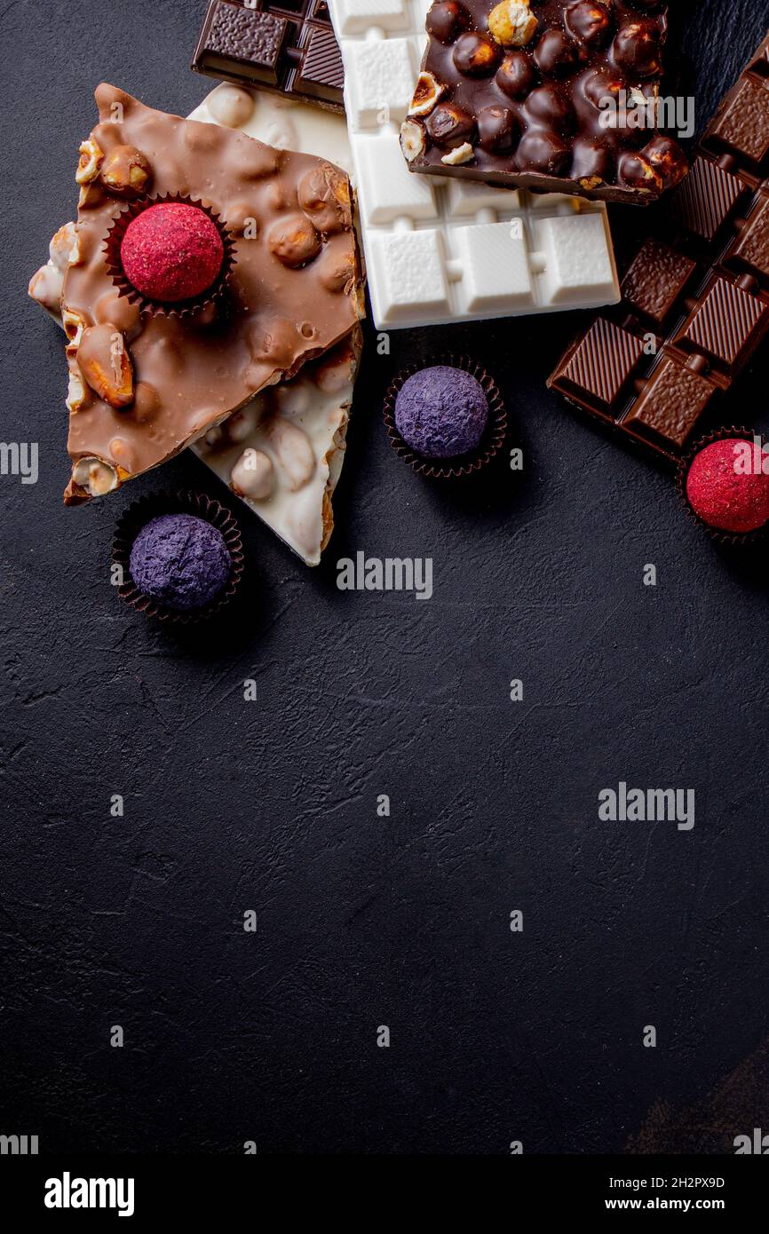 Chocolate bar, crushed pieces of dark chocolate and nuts. Praline ...