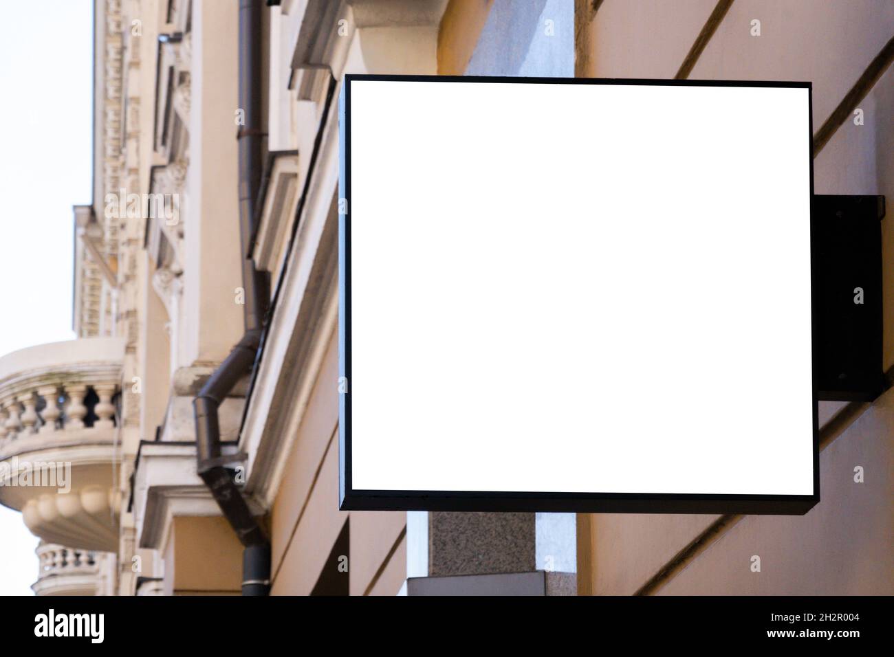 Mock up. Blank white rectangular shape signboard on the wall outdoors ...