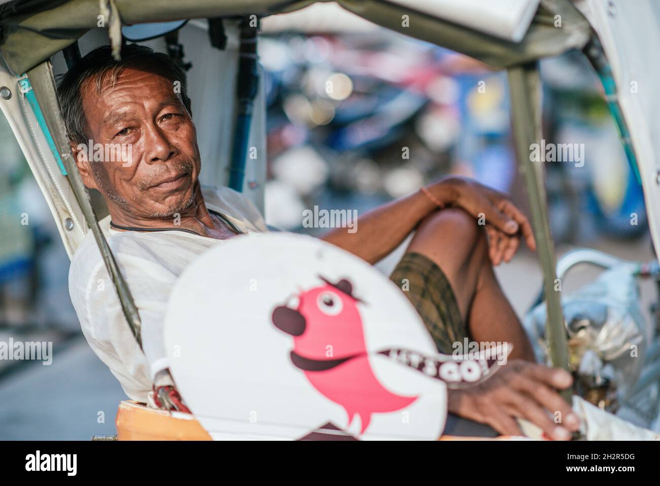 Rickshaw driver taking a break in Hua Hin. This is an old fishing ...