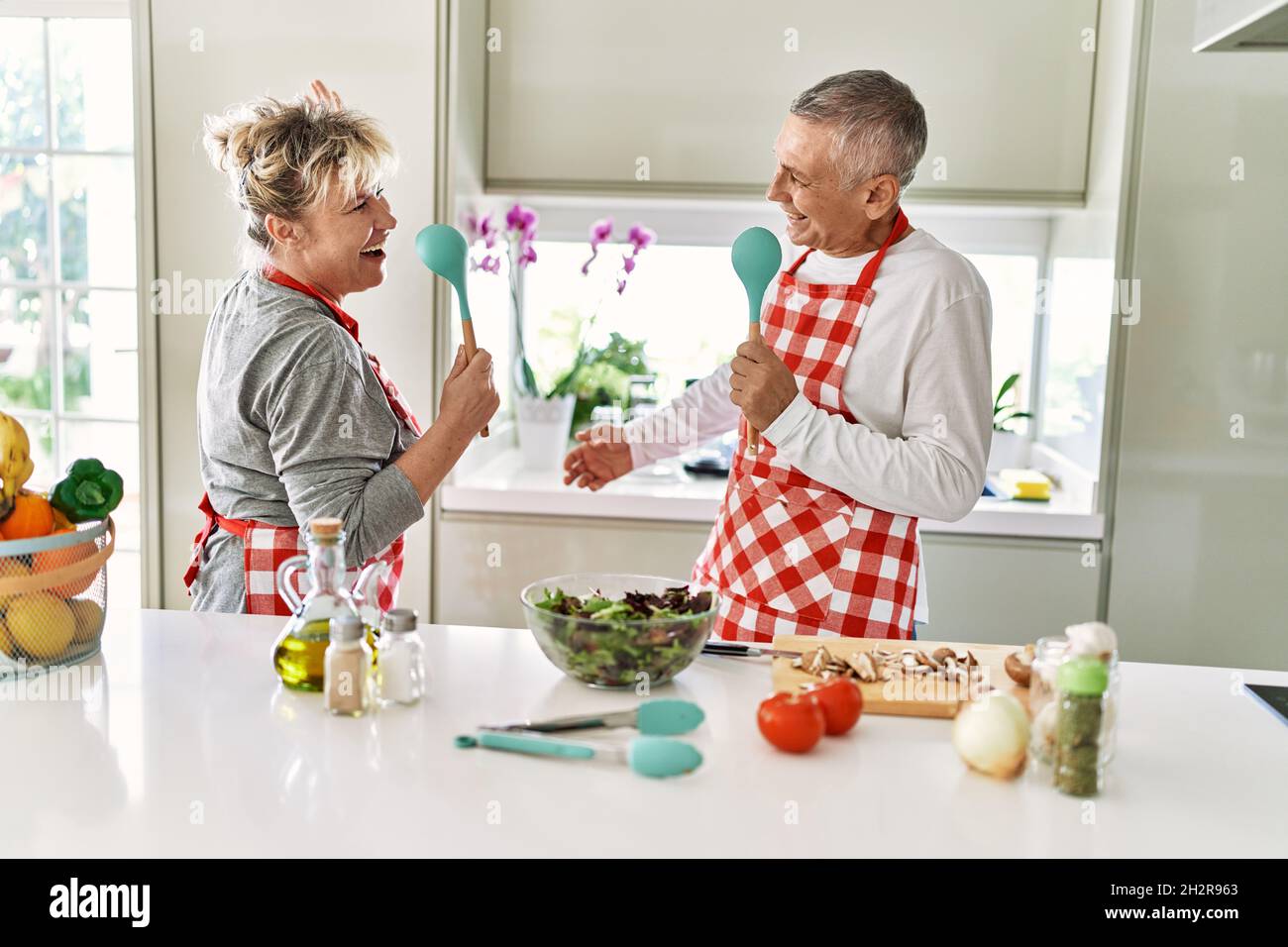 Senior caucasian couple smiling happy cooking at the kitchen Stock ...
