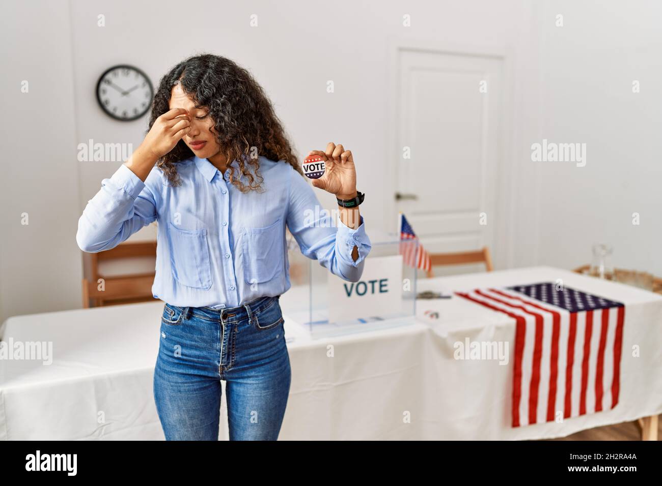 Beautiful hispanic woman standing by at political campaign by voting ...