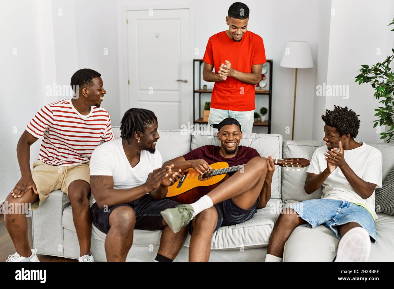 Group of african american people having party playing classical guitar ...